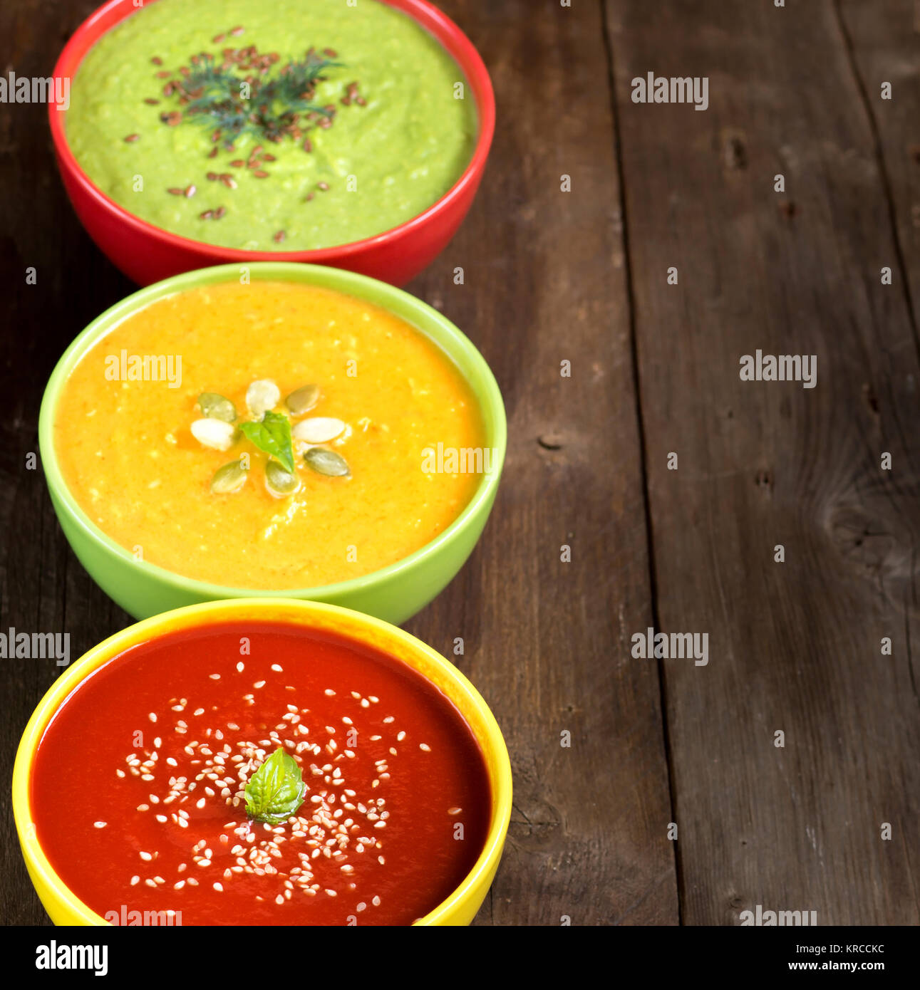 Three fresh soups on a wooden table Stock Photo - Alamy