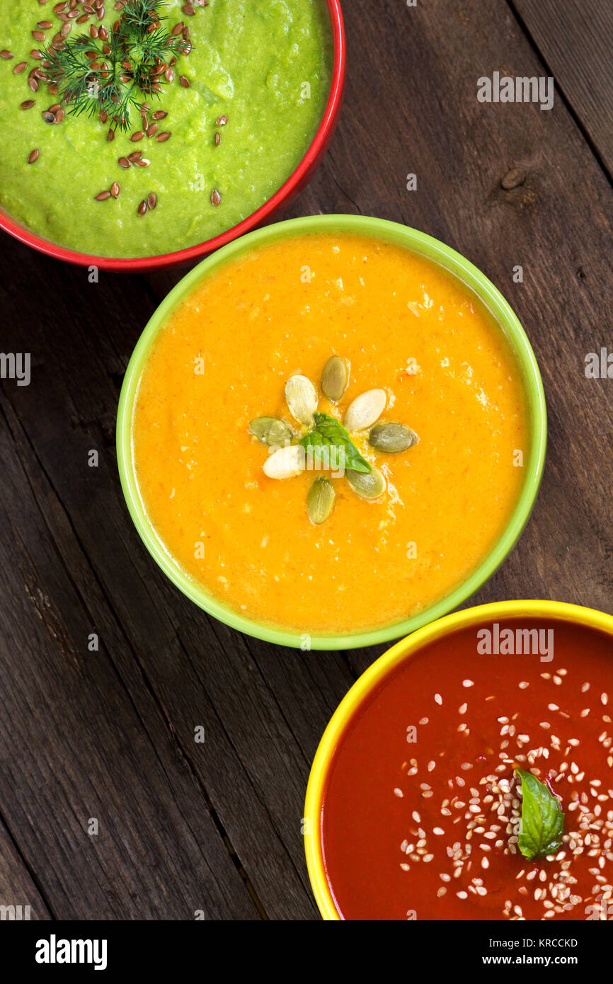 Three fresh soups on a wooden table Stock Photo - Alamy