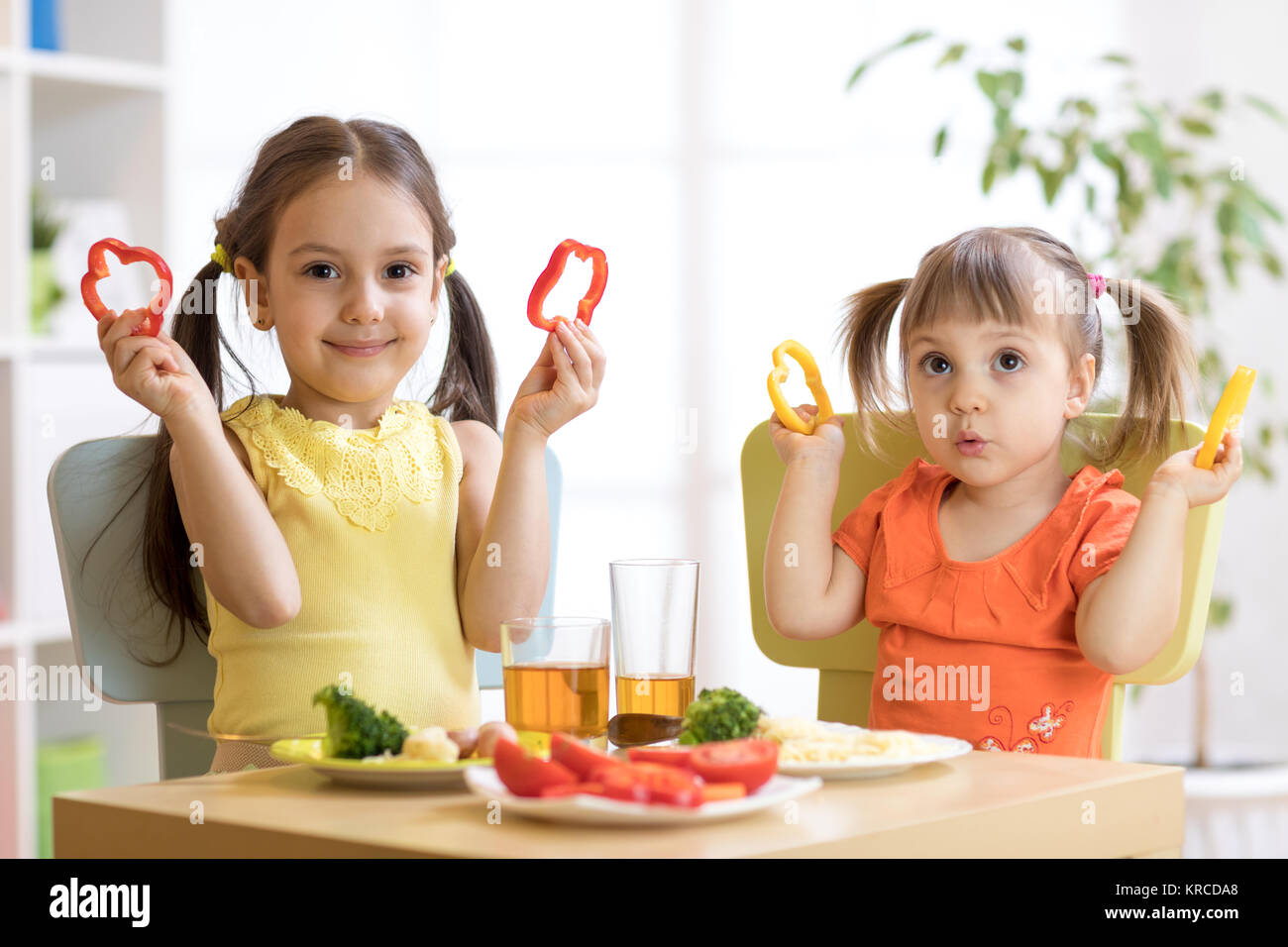happy children eating healthy food in kindergarten or at home Stock ...
