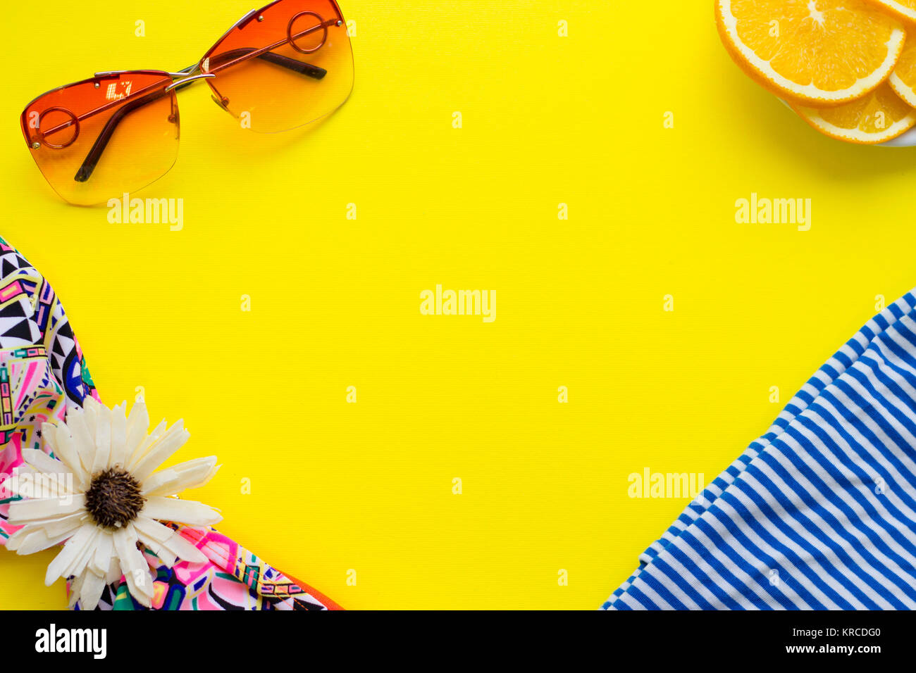 Bright yellow one-color background with a frame of tourist's outfit ...