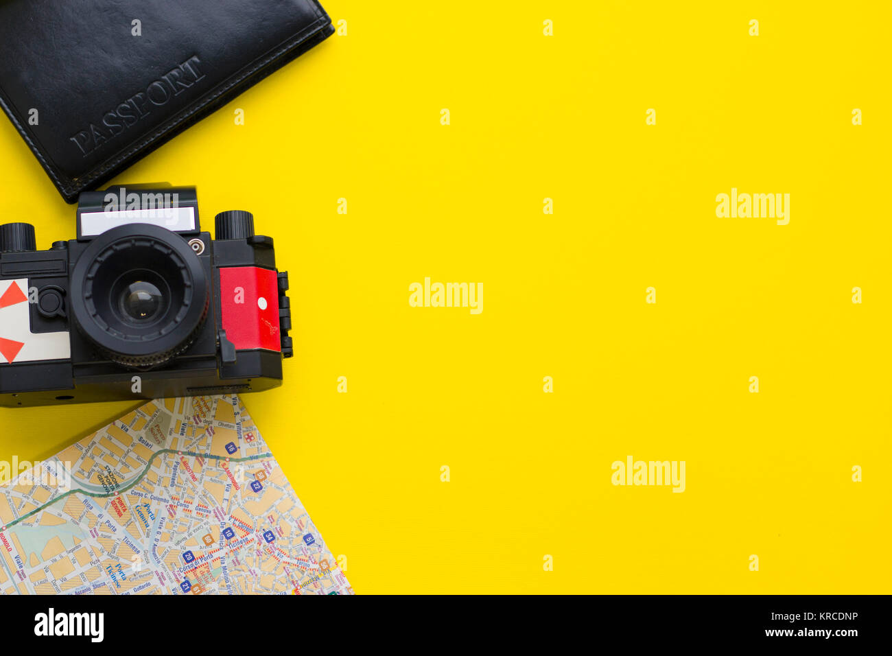 Bright yellow one-color background with tourist's accessories, top view ...