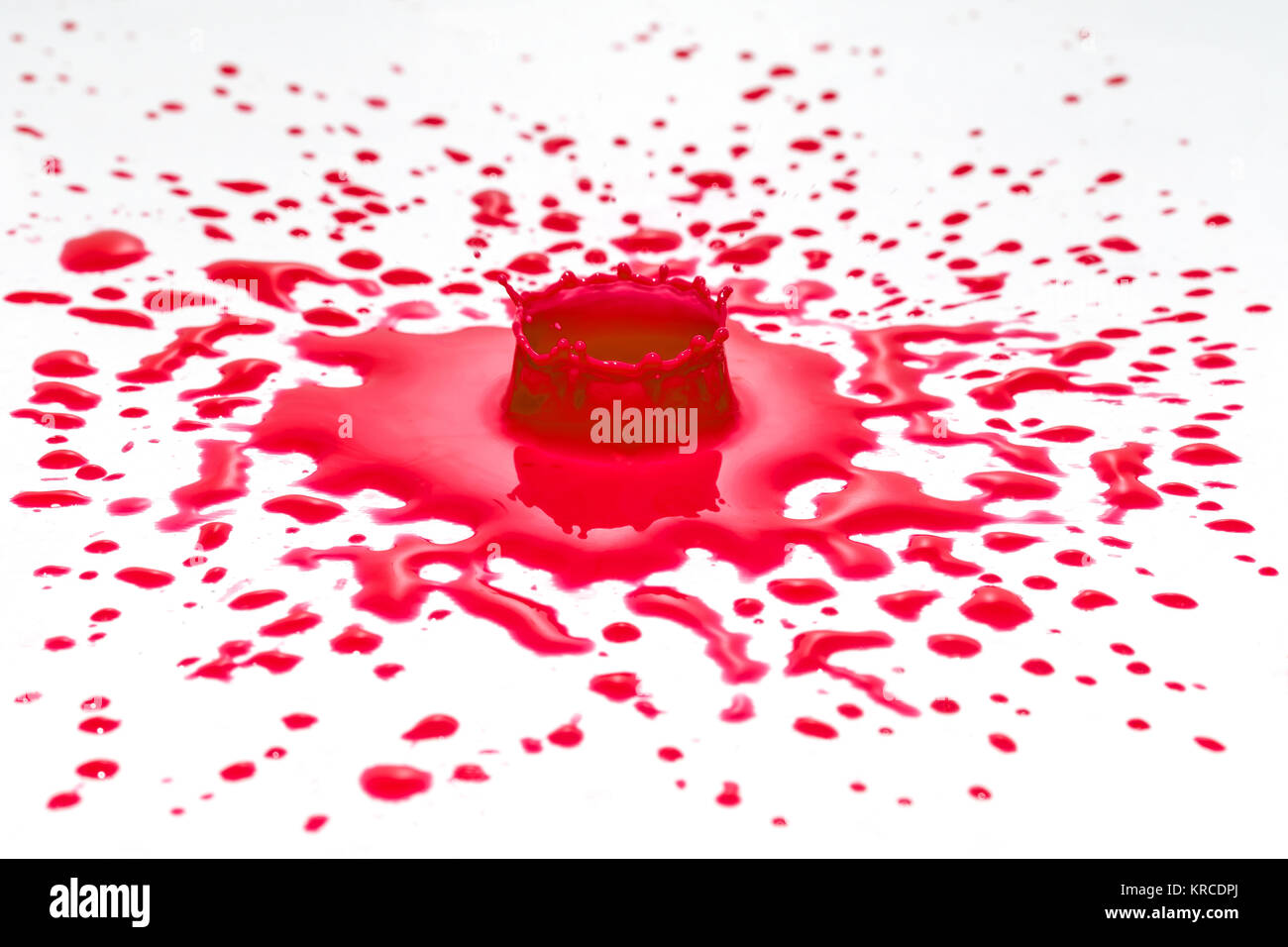 Impact of red color water drop Stock Photo - Alamy