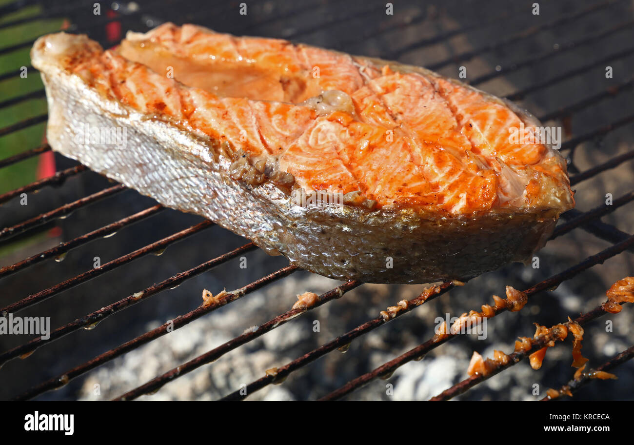 Salmon fish steak barbecue grill cooking close up Stock Photo - Alamy