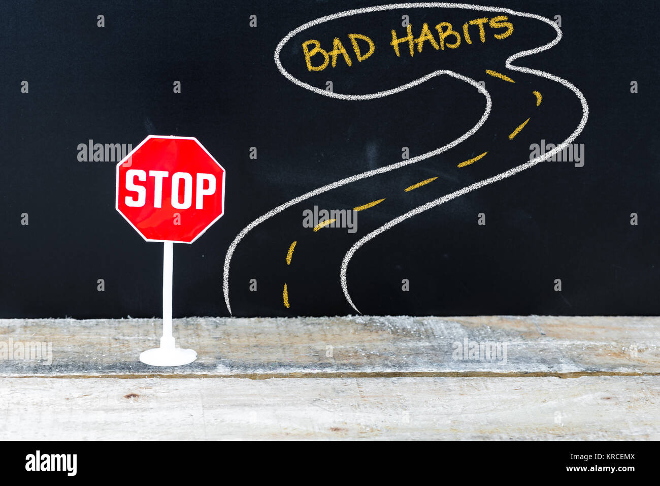 Mini STOP sign on the road to BAD HABITS Stock Photo - Alamy
