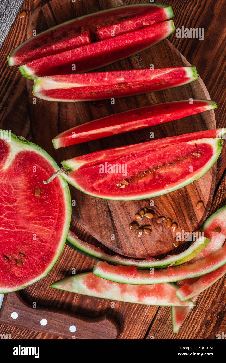 Watermelon slices and peels lying on the board Stock Photo - Alamy