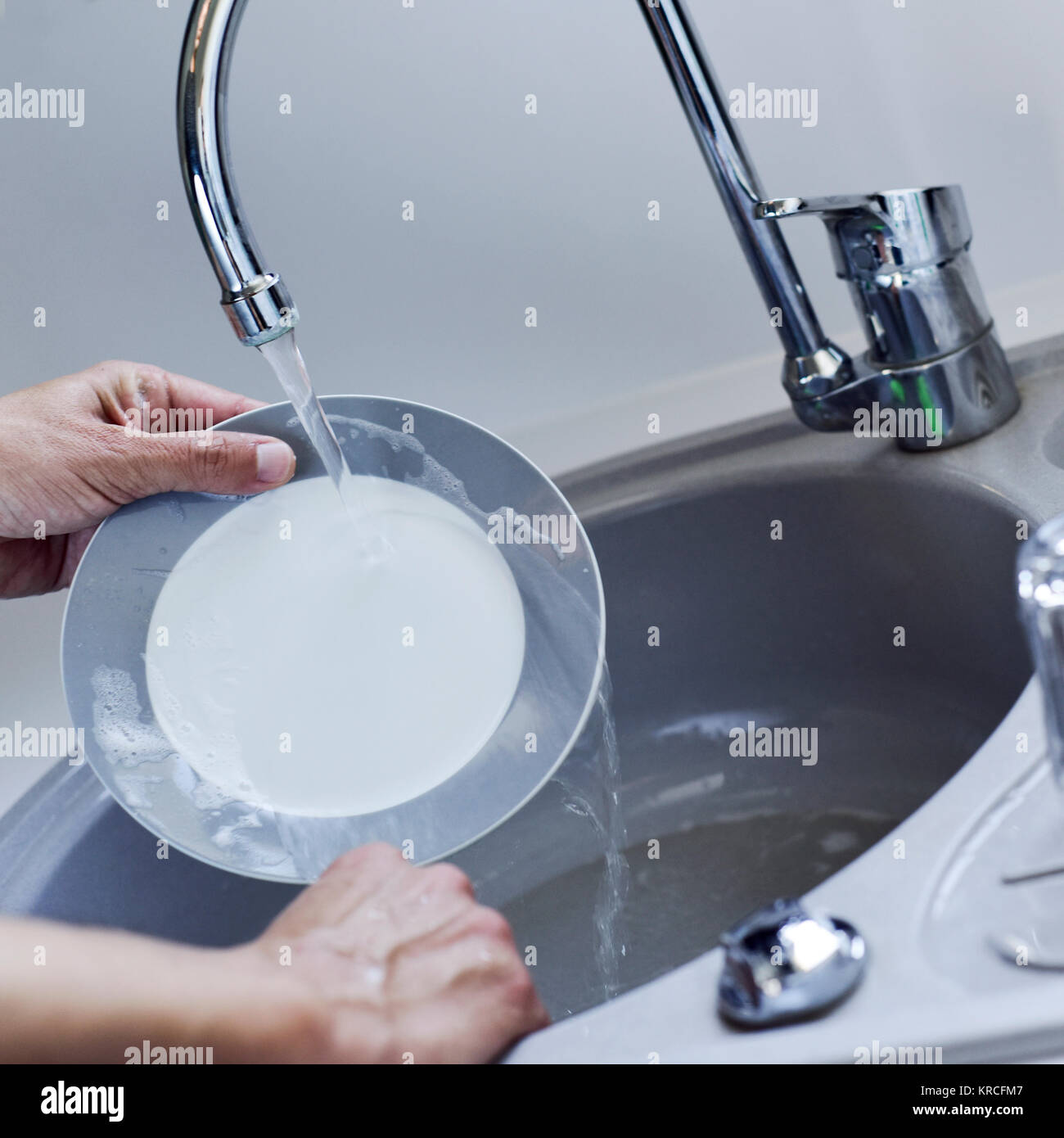 Man washing dishes in kitchen hi-res stock photography and images - Alamy