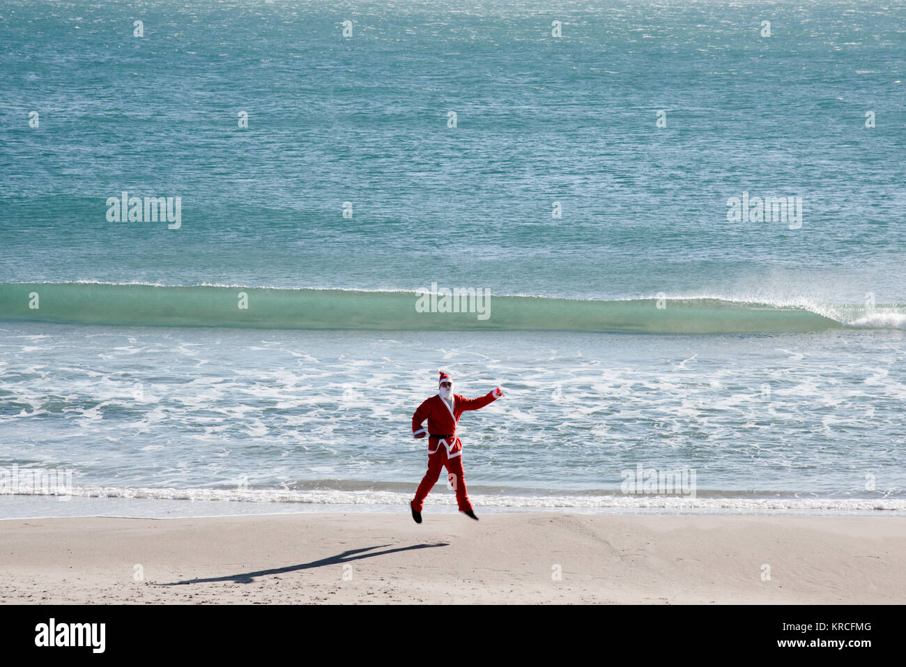 santa claus jumping on the beach with the sea in the background Stock ...