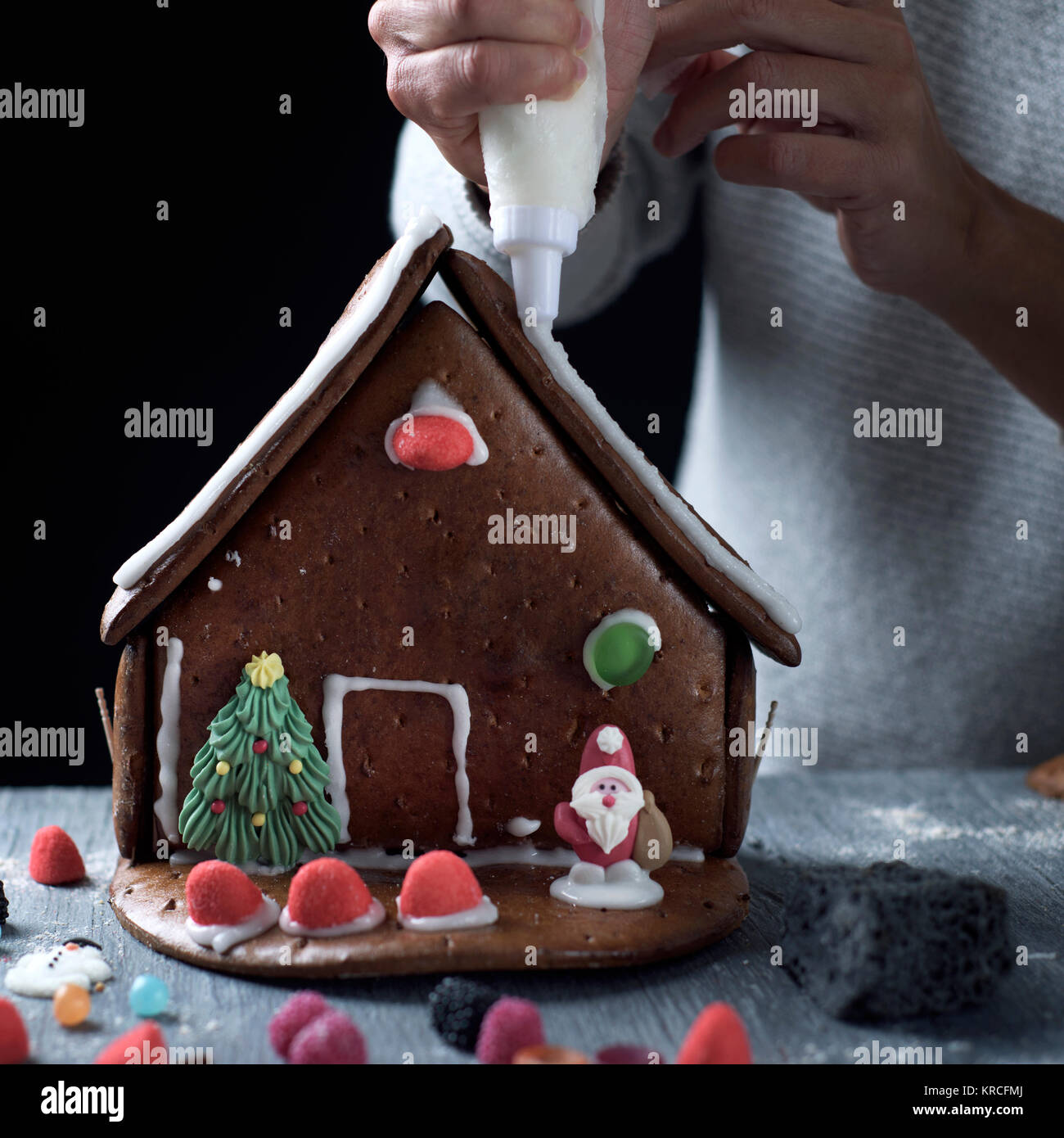 closeup of a young caucasian man decorating a messy homemade ...