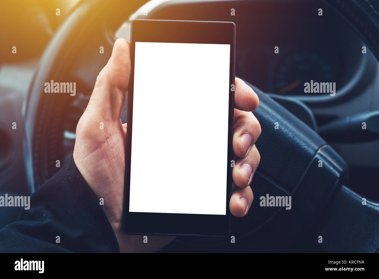 Man using smartphone in car with blank screen of mobile phone device as ...