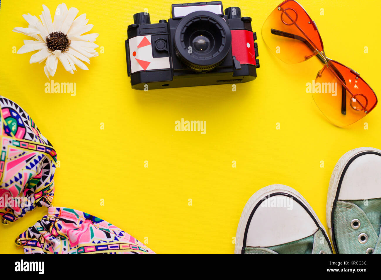 Travel or tourism concept. Seaside vacation items on a bright yellow ...