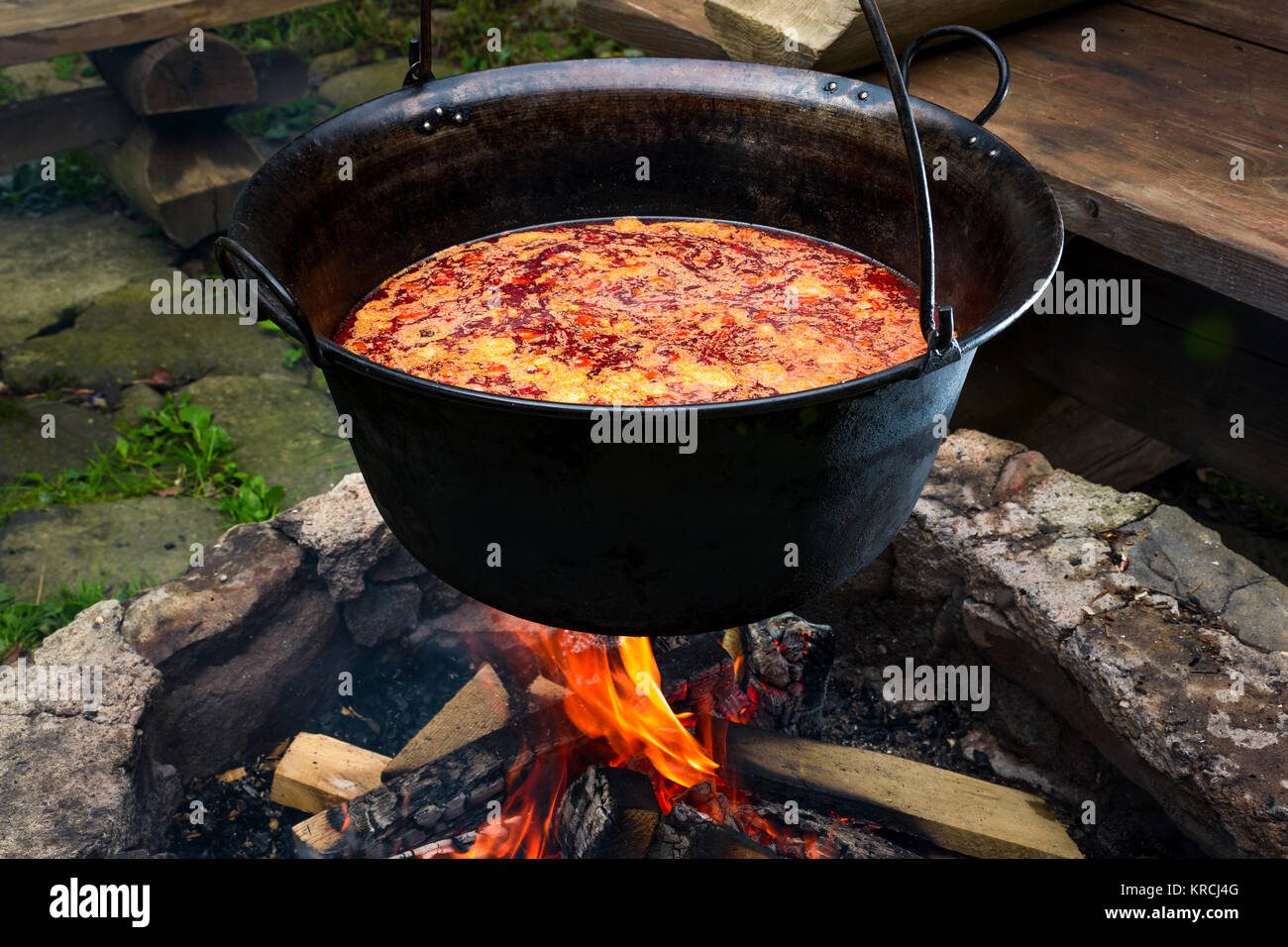traditional Hungarian Goulash soup in cauldron. meal cooked outdoors on ...