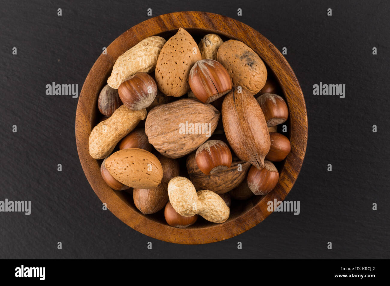 Mixed nuts in shells in a bowl Stock Photo - Alamy