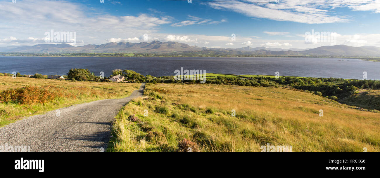 A narrow mountain pass road leads down the slopes of Caherconree ...