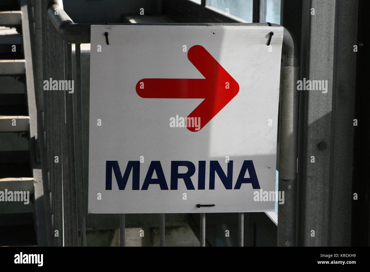 Public indoors sign for direction to marina Stock Photo - Alamy