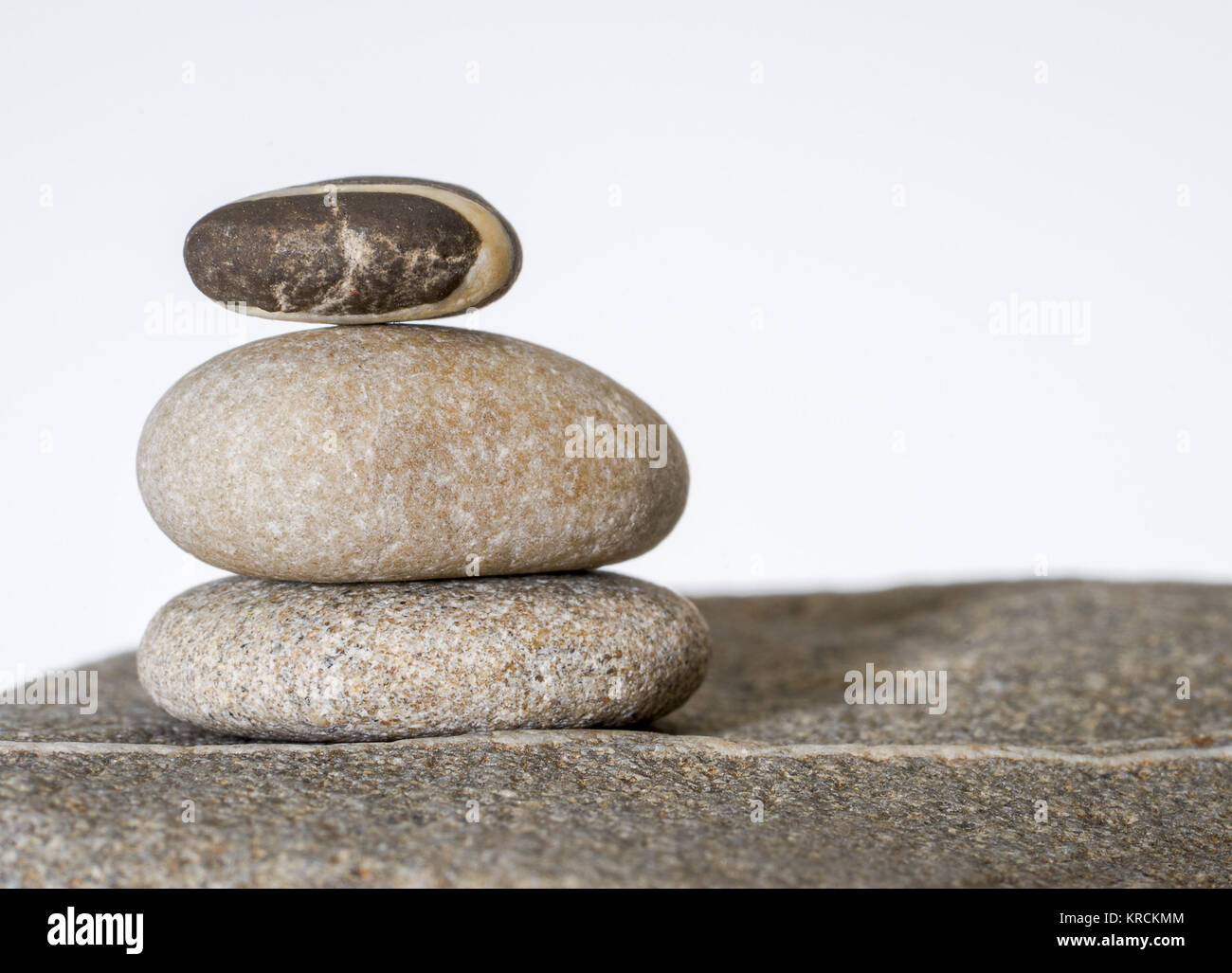 stacked rounded stone pebble arrangement in light back Stock Photo - Alamy