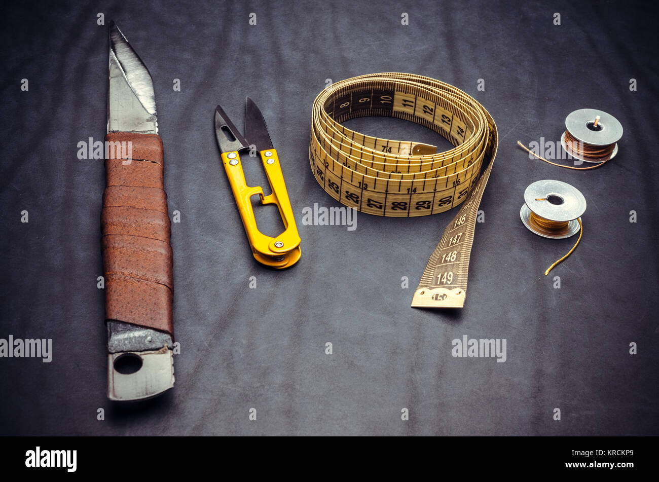 tailor's tools on a black background Stock Photo - Alamy