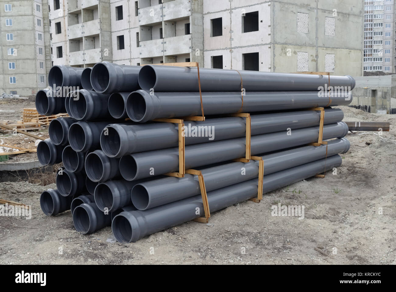 Close up of rubber pipes on pile and other construction material and ...