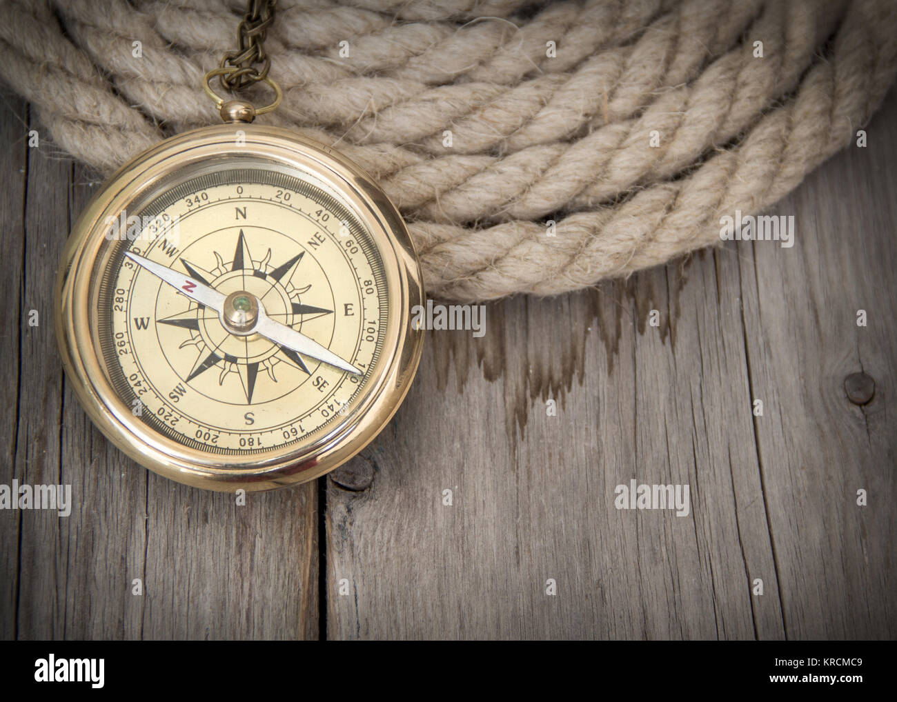 Exploring background with compass and rope Stock Photo - Alamy