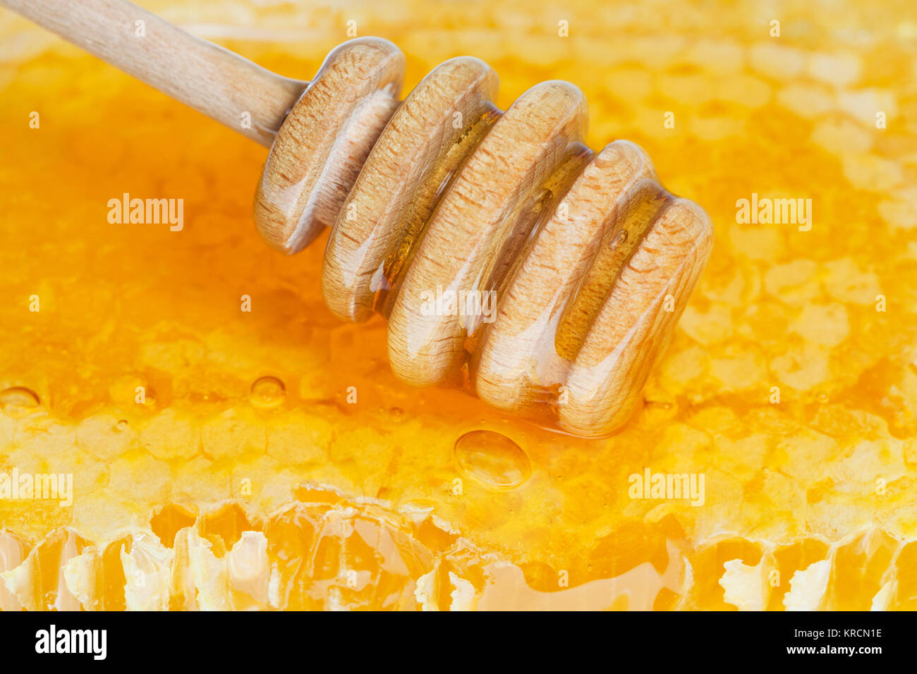 wooden honey spoon on surface of honeycomb Stock Photo - Alamy