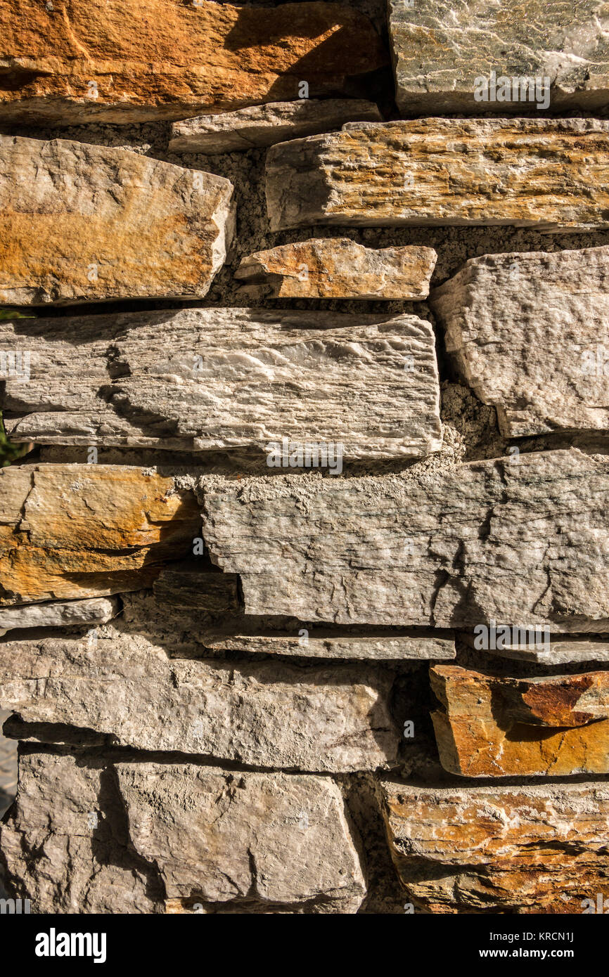 Stone wall with warm colors and individual structure Stock Photo - Alamy