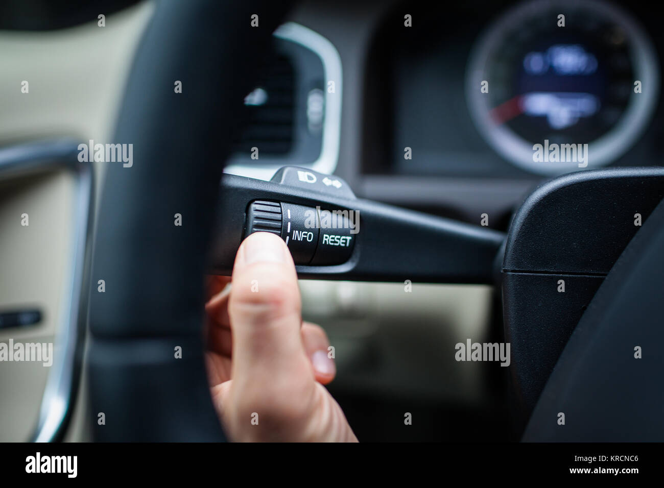Modern car interior - driver pressing a button, using the car computer ...