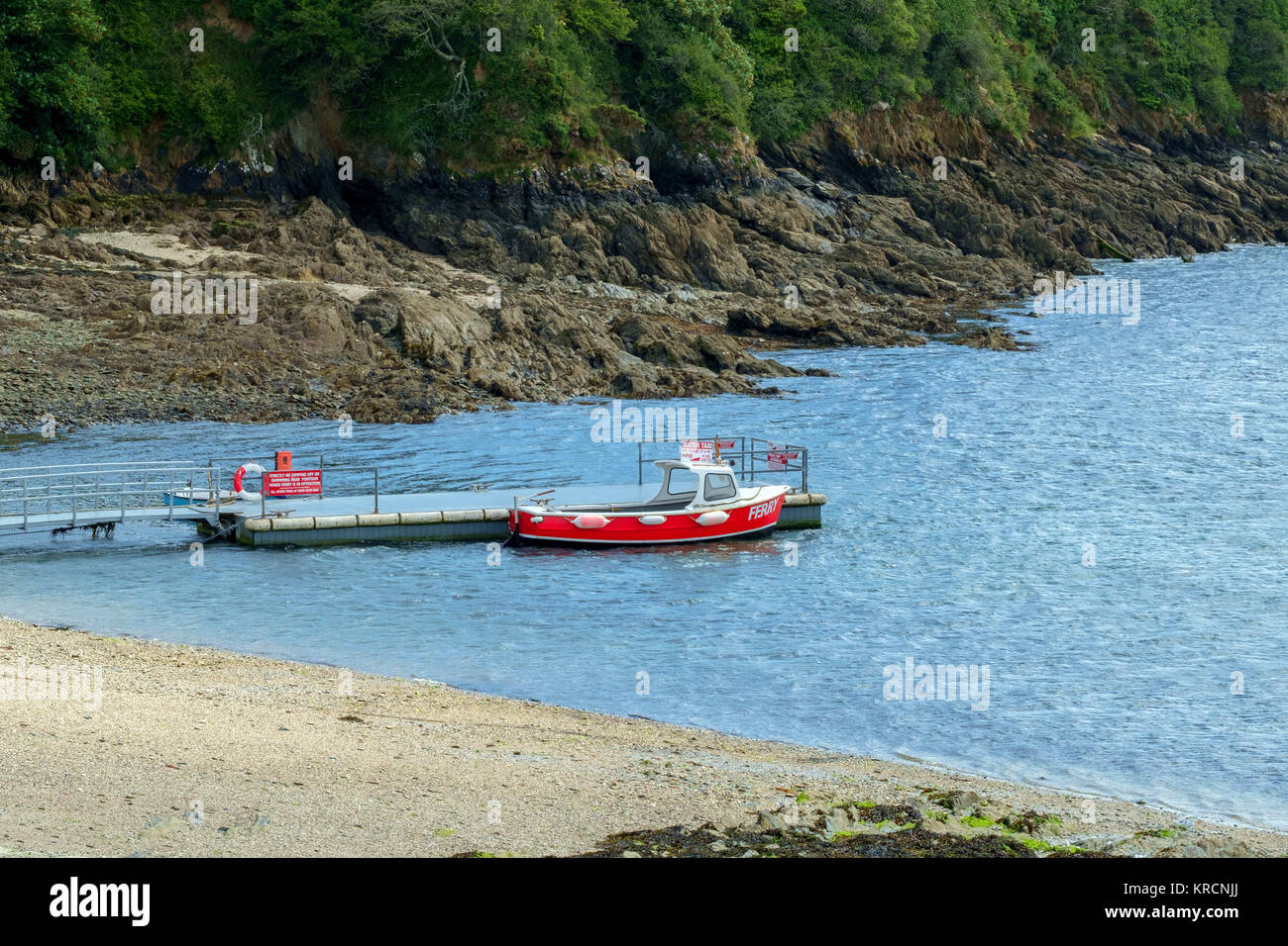 Water taxi passenger ferry waits at the pontoon on Helford Passage ...