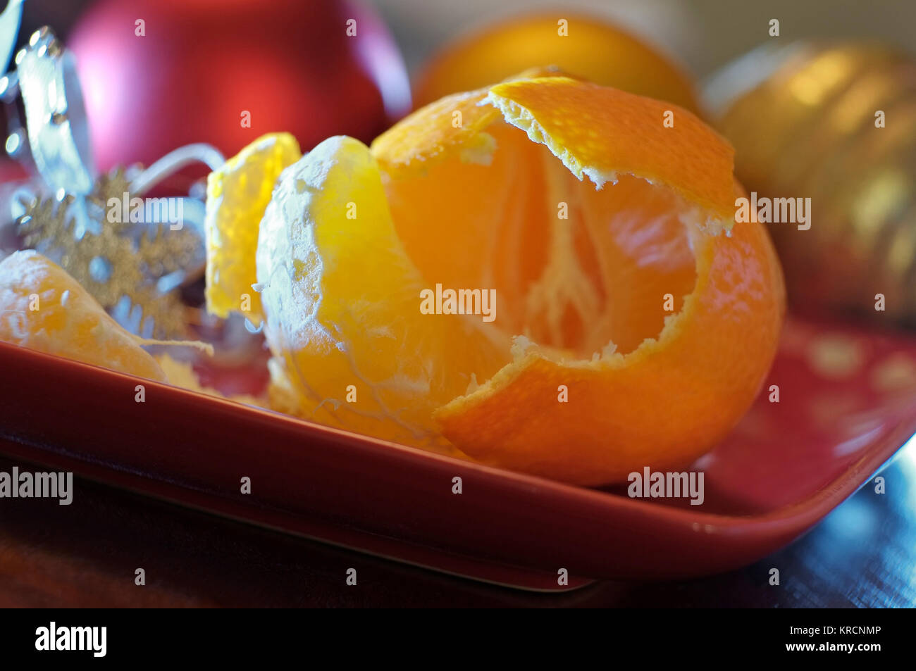 peeled small orange on plate Stock Photo - Alamy