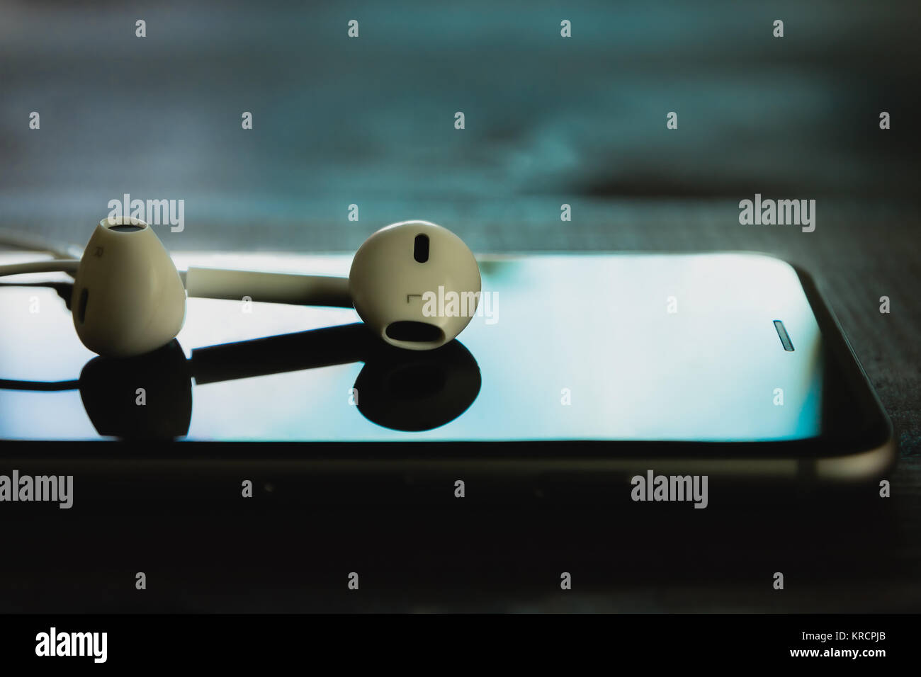 close up headphone stack on phone in black color tone, new headphone ...