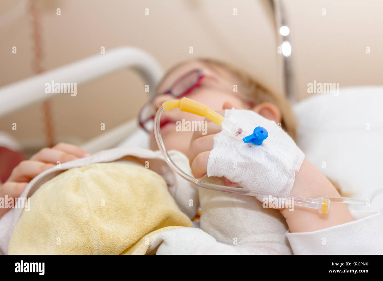 Little girl is receiving medication through intravenous fluid therapy ...