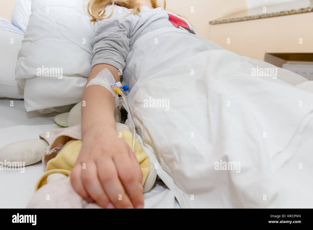 Little girl is receiving medication through intravenous fluid therapy ...