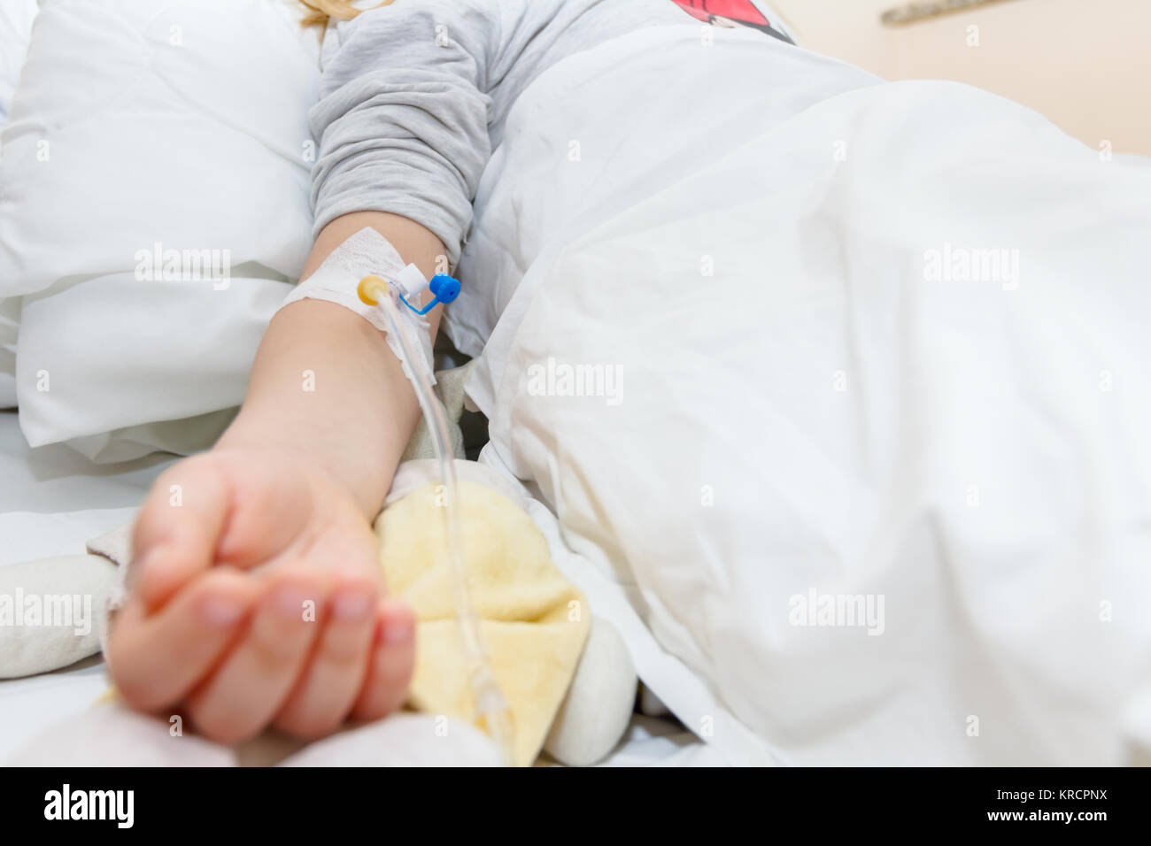 Little girl is receiving medication through intravenous fluid therapy ...
