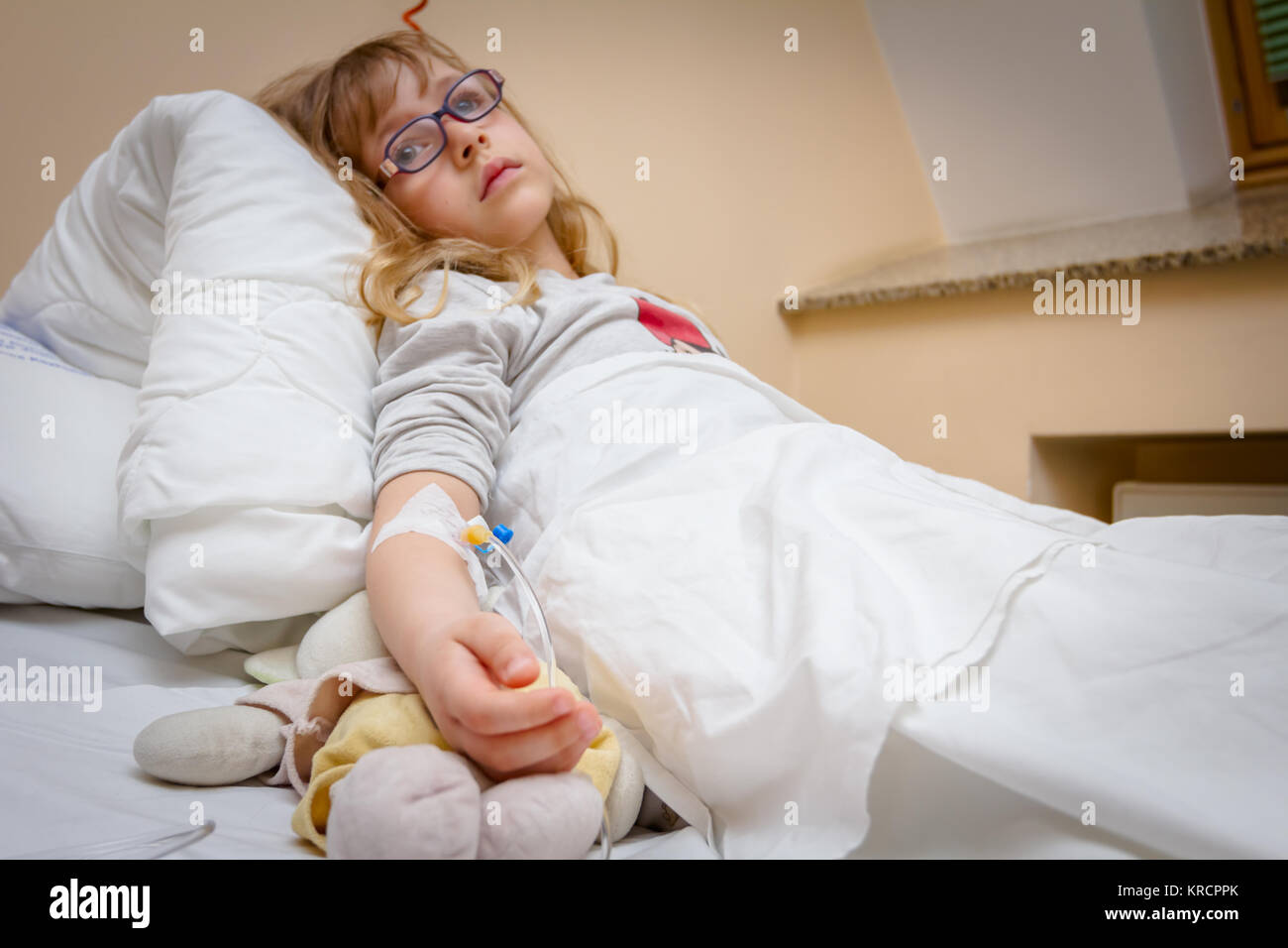 Little girl is receiving medication through intravenous fluid therapy ...