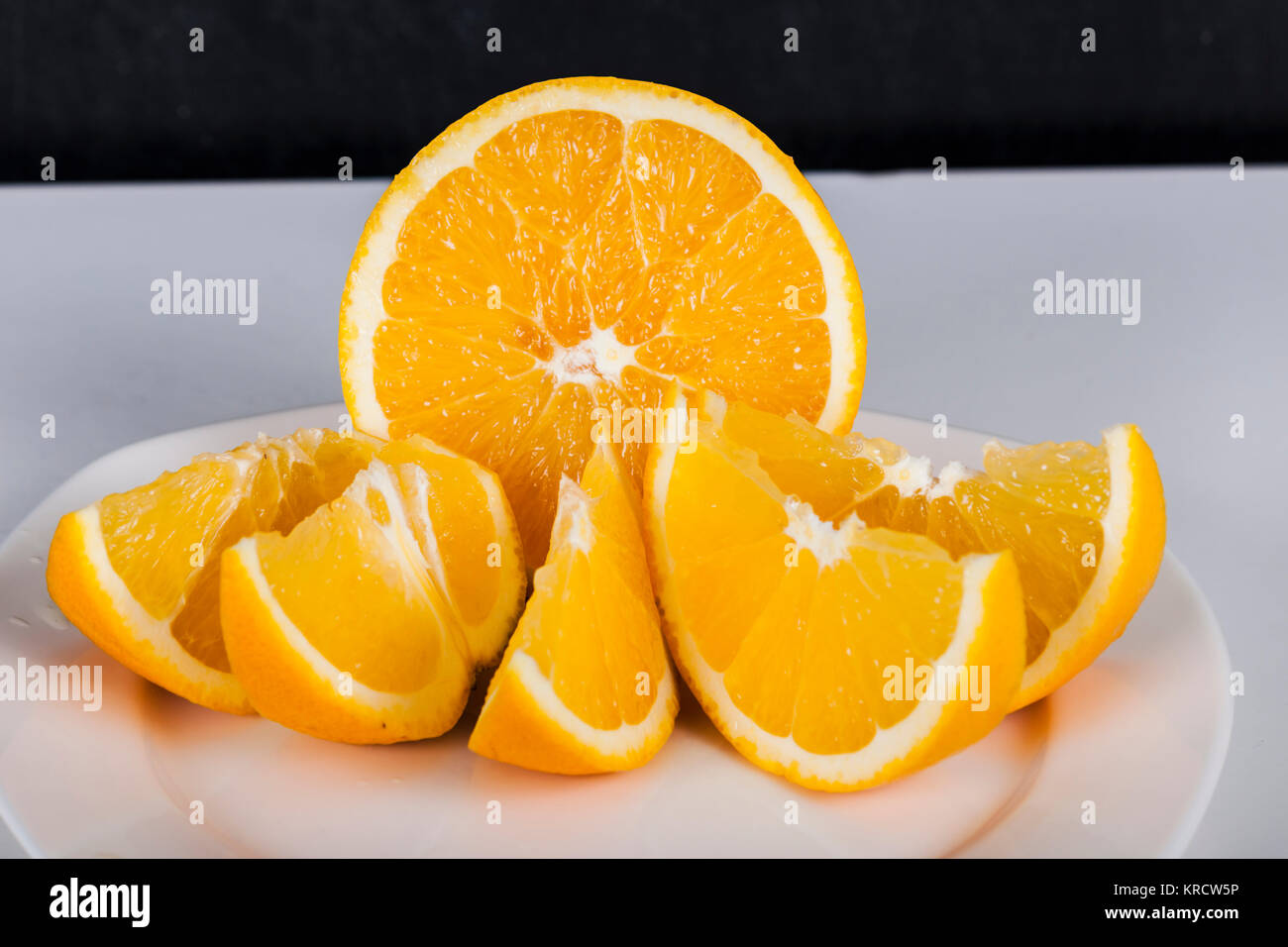 Fresh orange sliced on the dish Stock Photo - Alamy