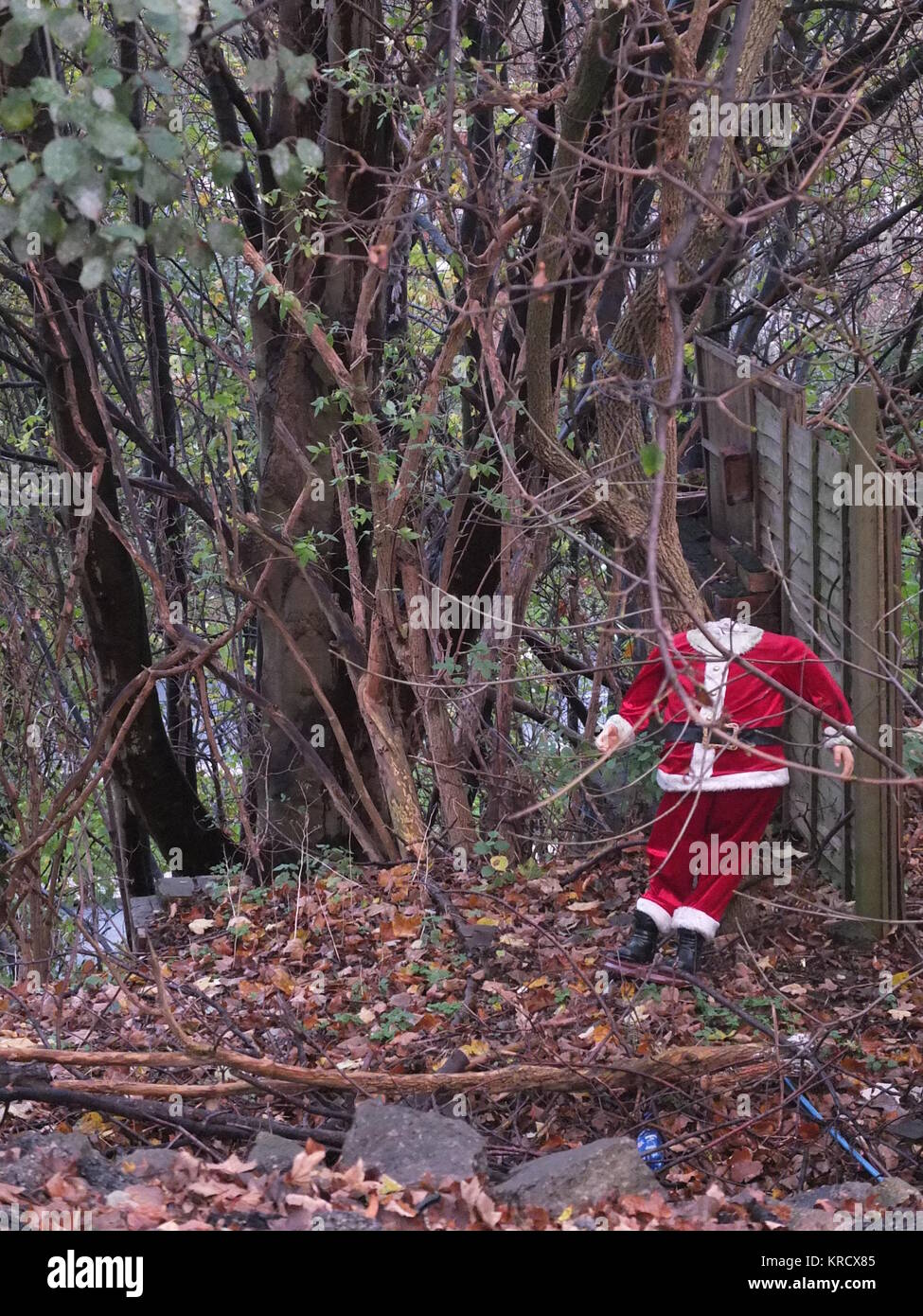 A headless Santa Claus / Father Christmas mannequin on waste ground ...