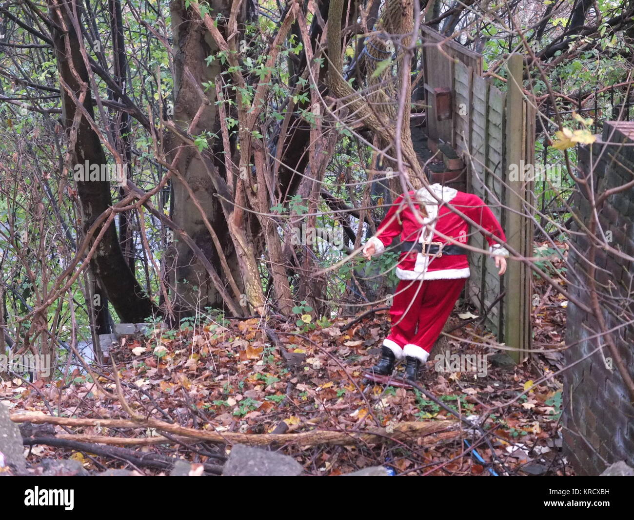 A headless Santa Claus / Father Christmas mannequin on waste ground ...
