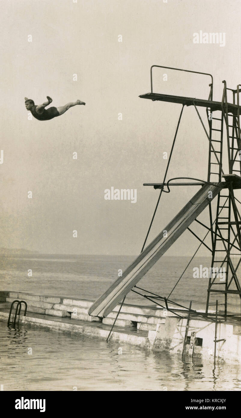 Man diving into an outdoor pool at a seaside resort Stock Photo - Alamy