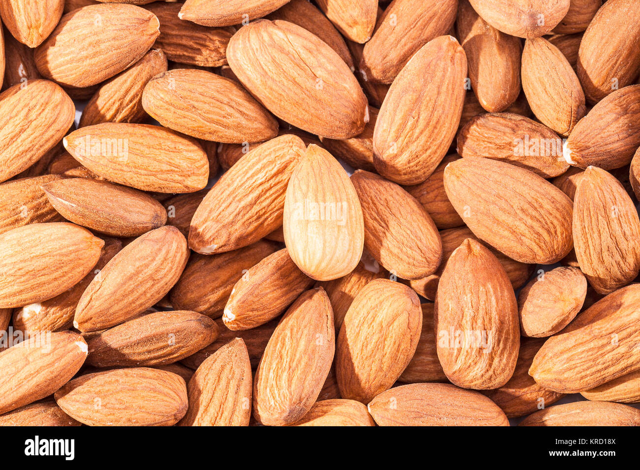 Background of whole almonds group close up Stock Photo - Alamy