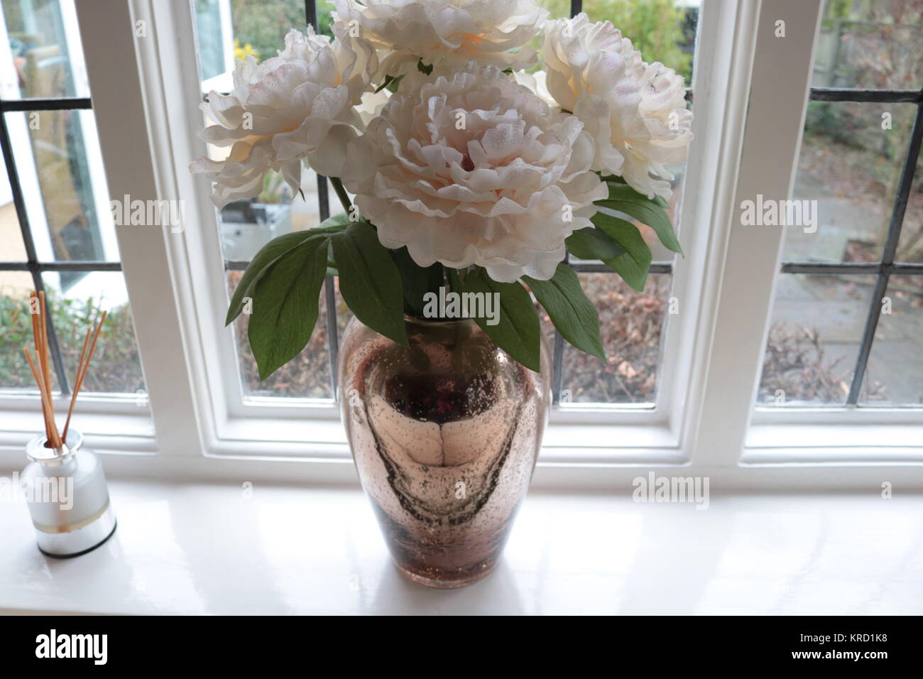 Flowers in a vase on a window Stock Photo - Alamy