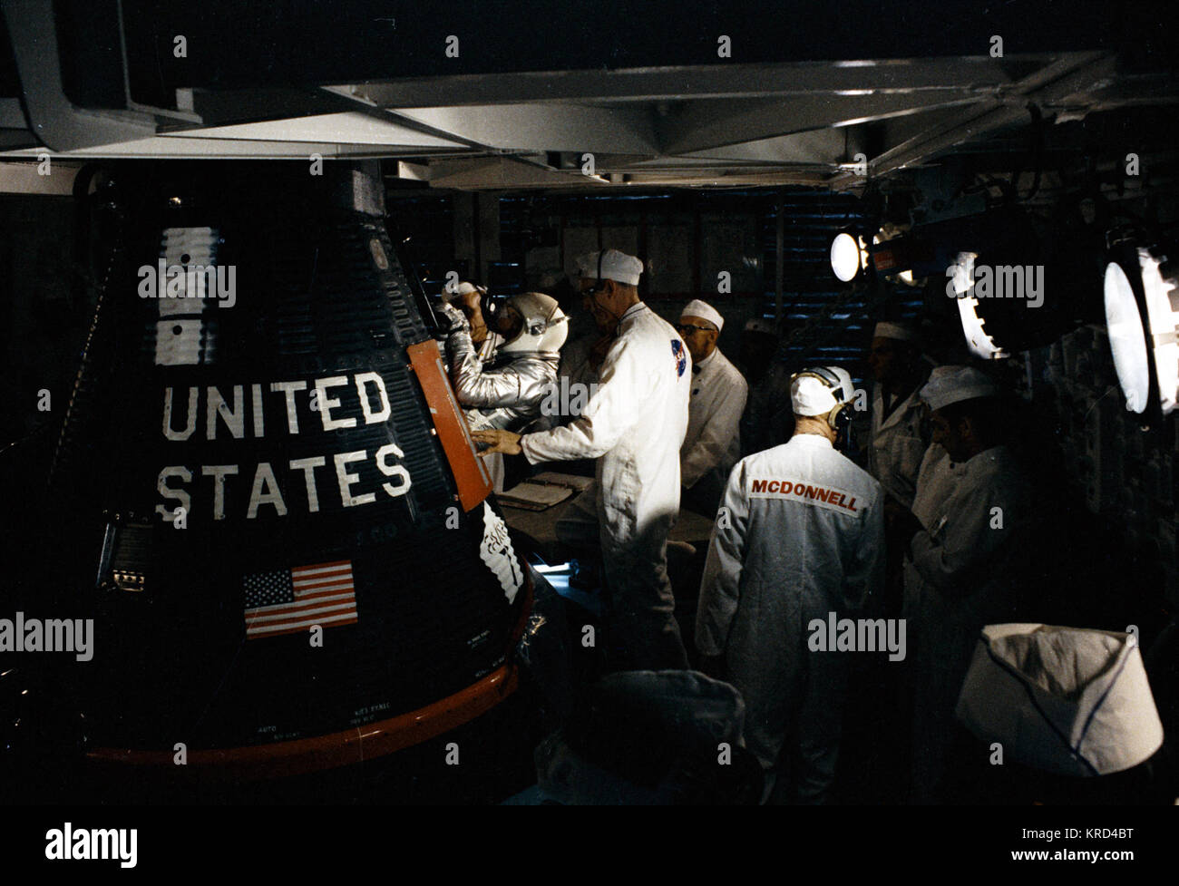 Astronaut L. Gordon Cooper Jr. is assisted into his Faith 7 Mercury ...