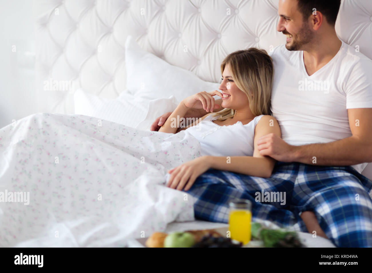 Romantic couple kissing in bed hi-res stock photography and images - Alamy