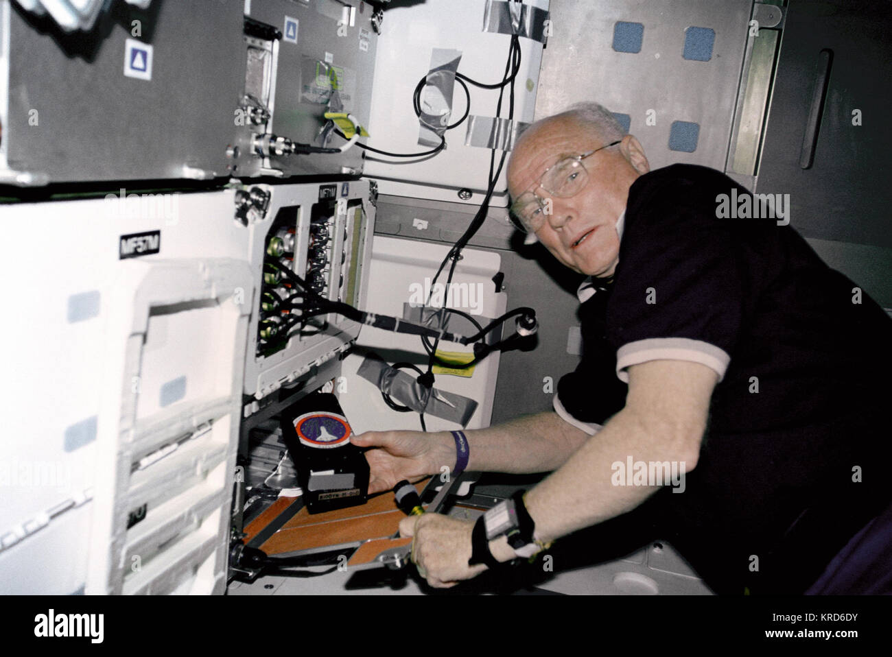 STS-95 payload specialist John Glenn works with the Osteporosis Experiment in Orbit (OSTEO ...