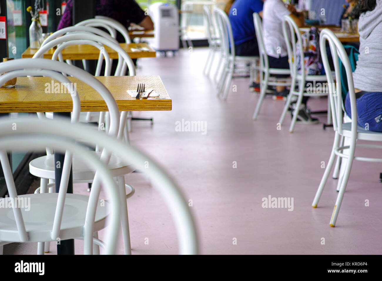 Bright modern cafe interior with big windows, wooden tables and white ...