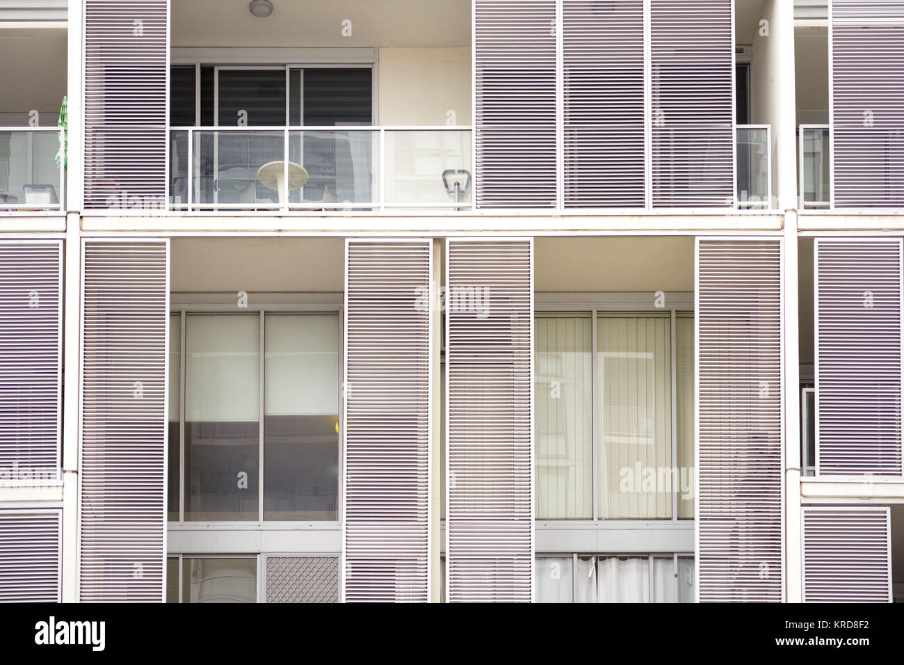 Modern residential building exterior closeup with balconies and wind ...