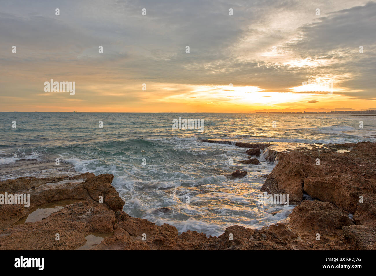 The calm sea in a very cloudy sunset in Spain Stock Photo - Alamy