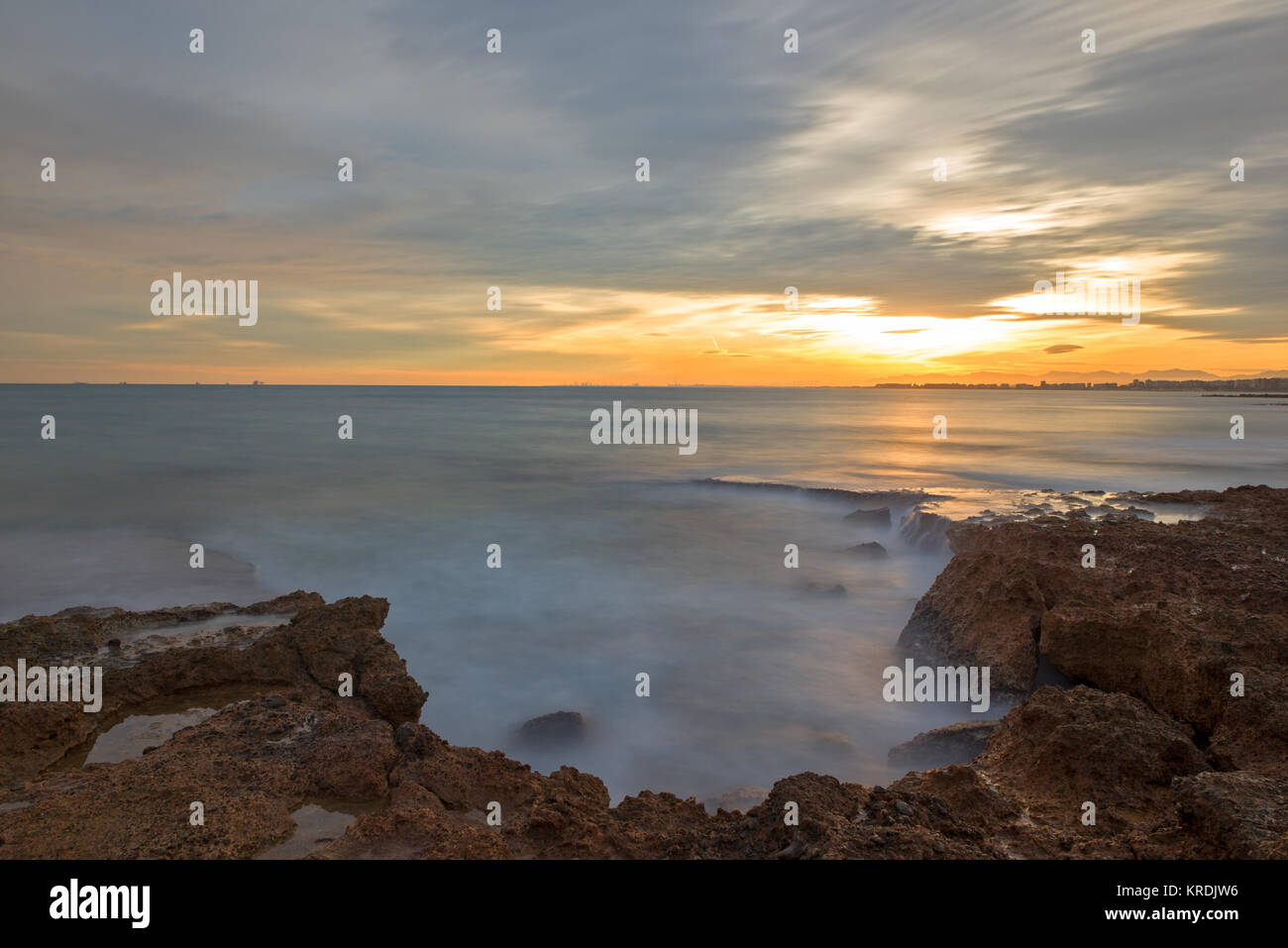 The calm sea in a very cloudy sunset in Spain Stock Photo - Alamy