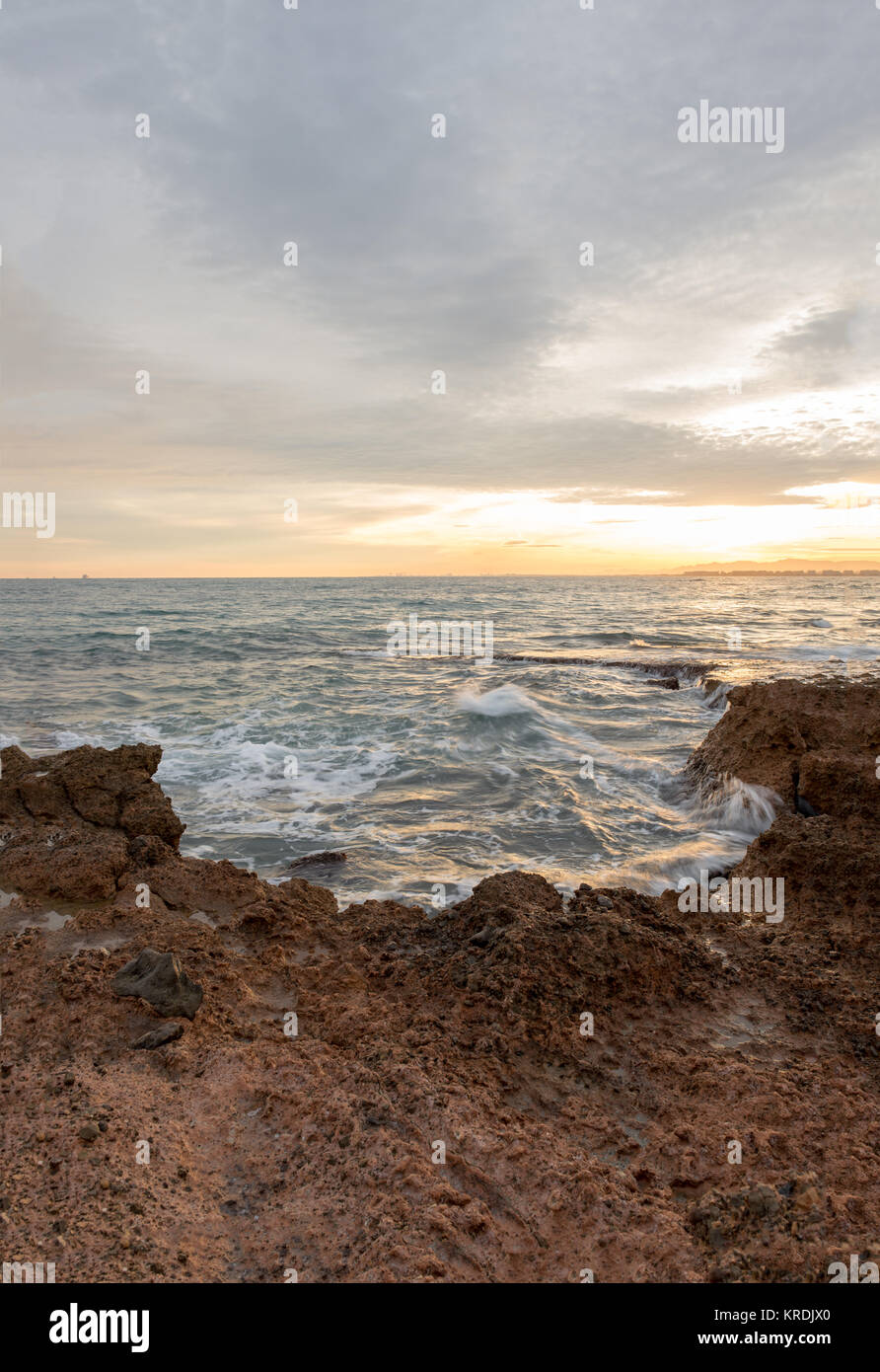 The calm sea in a very cloudy sunset in Spain Stock Photo - Alamy