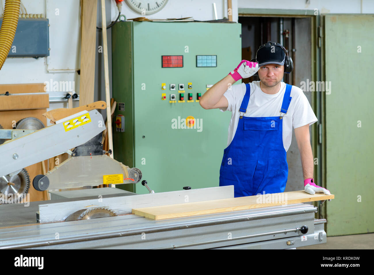 worker in a carpenter's workshop using saw machine Stock Photo - Alamy