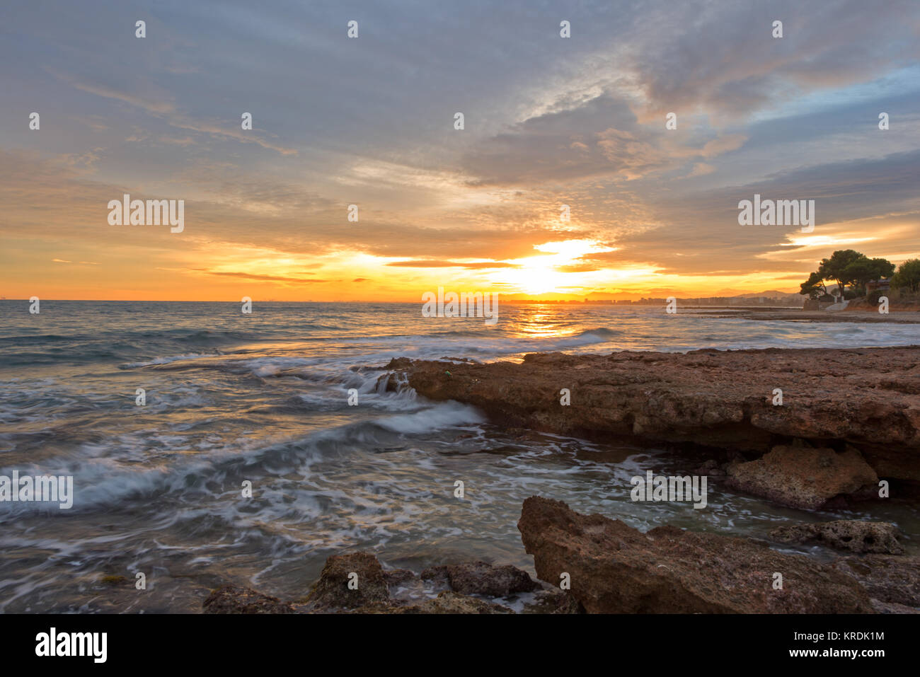 The calm sea in a very cloudy sunset in Spain Stock Photo - Alamy