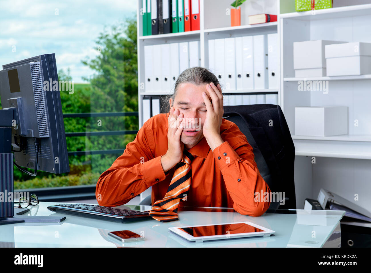 young tired business man lying with head in hands is over-worked Stock ...