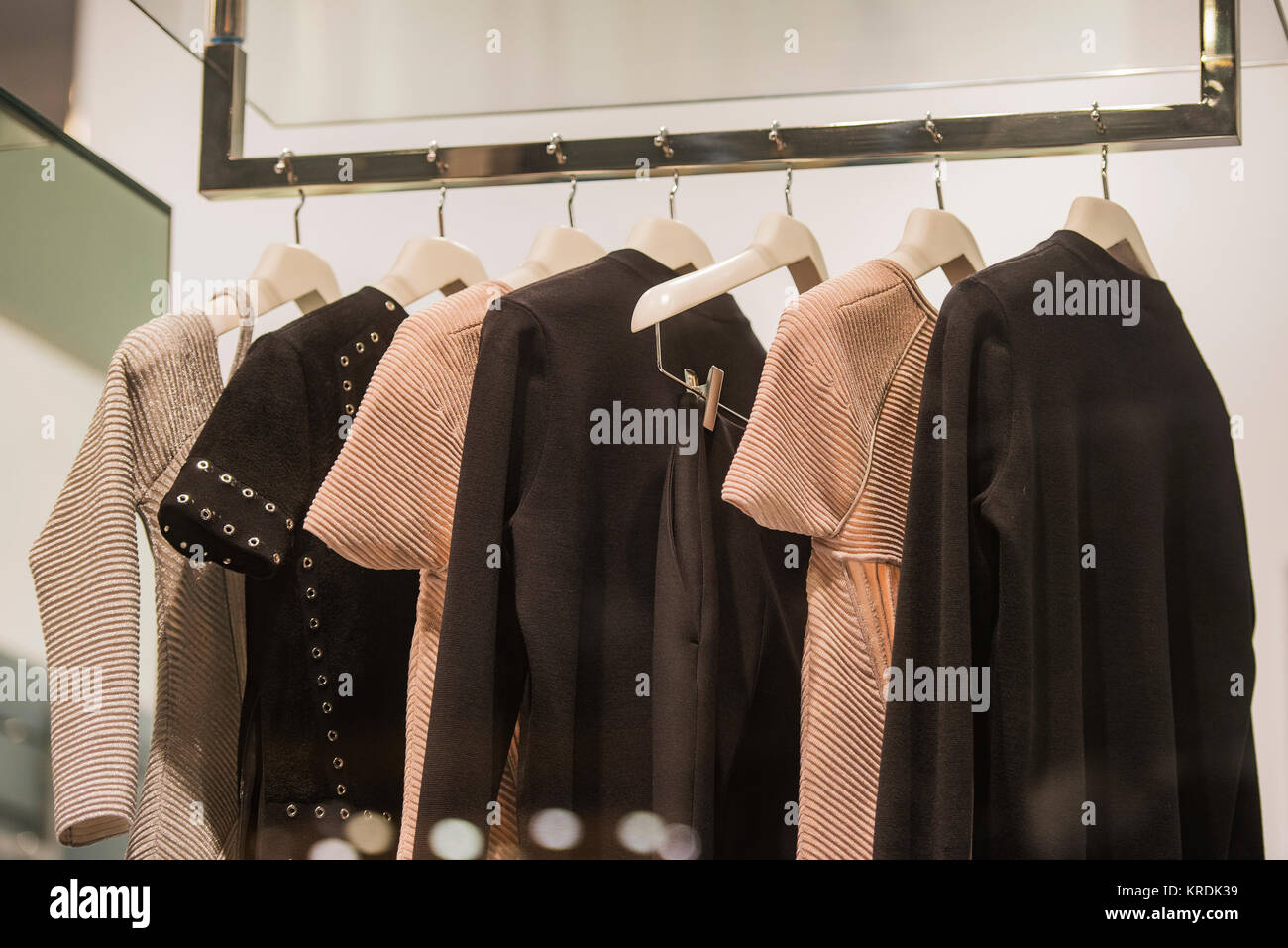 Women clothing on racks in a fashion store Stock Photo - Alamy